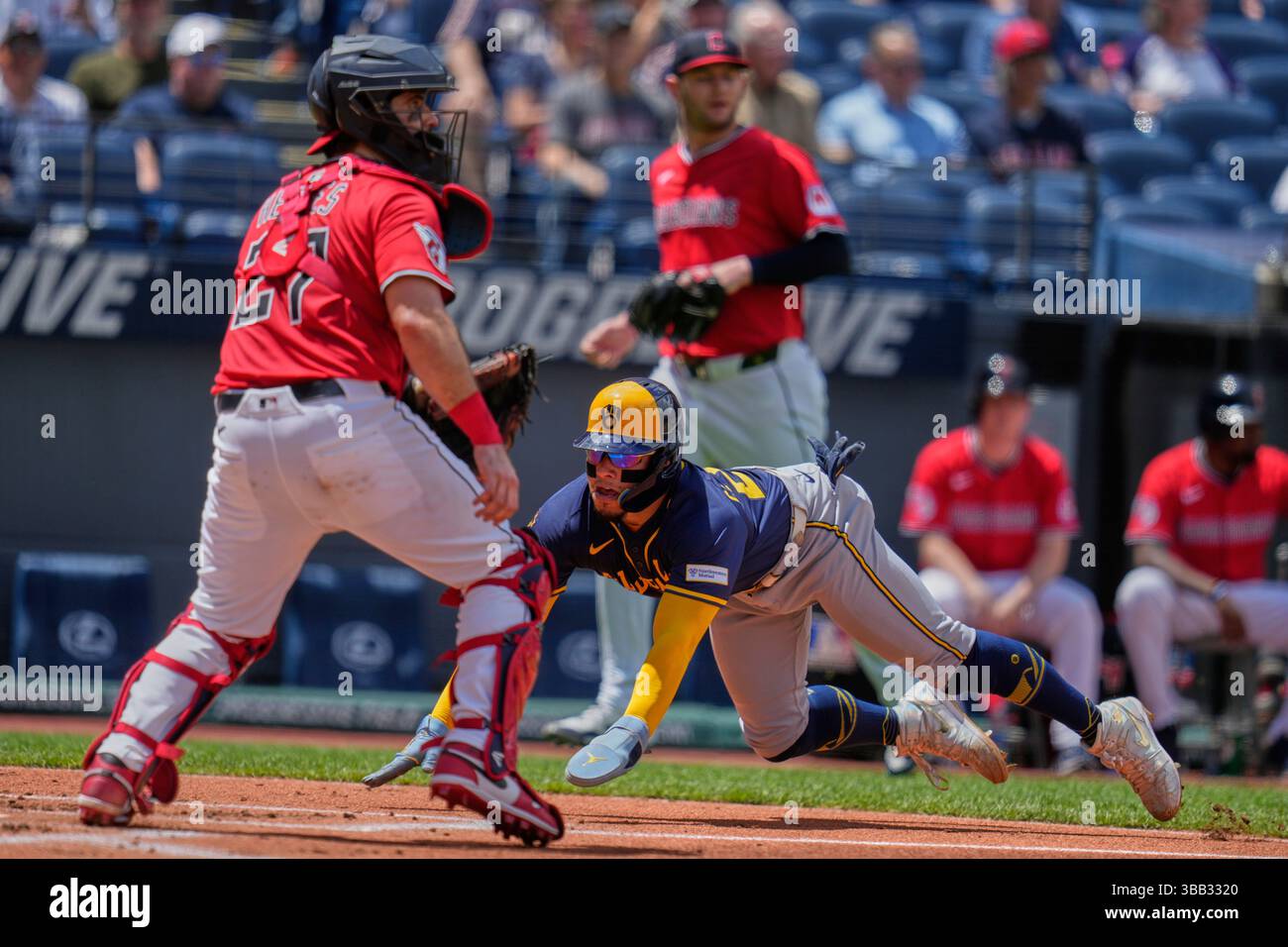 Milwaukee Brewers' William Contreras, right, begins his slide home to ...