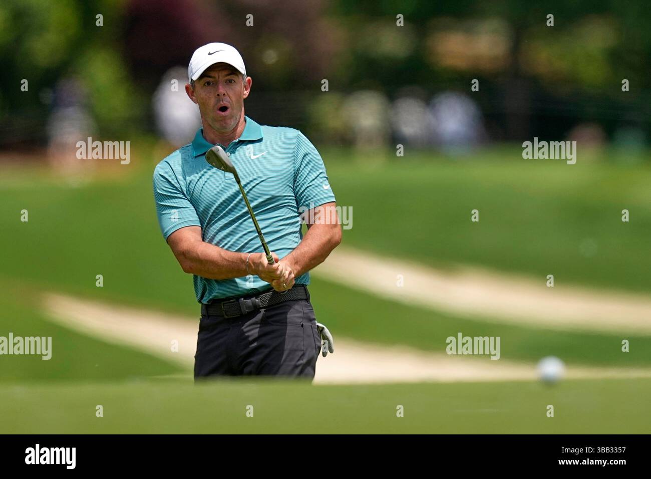 Rory McIlroy, of Northern Ireland, chips to the green on the 11th hole during a practice round ...