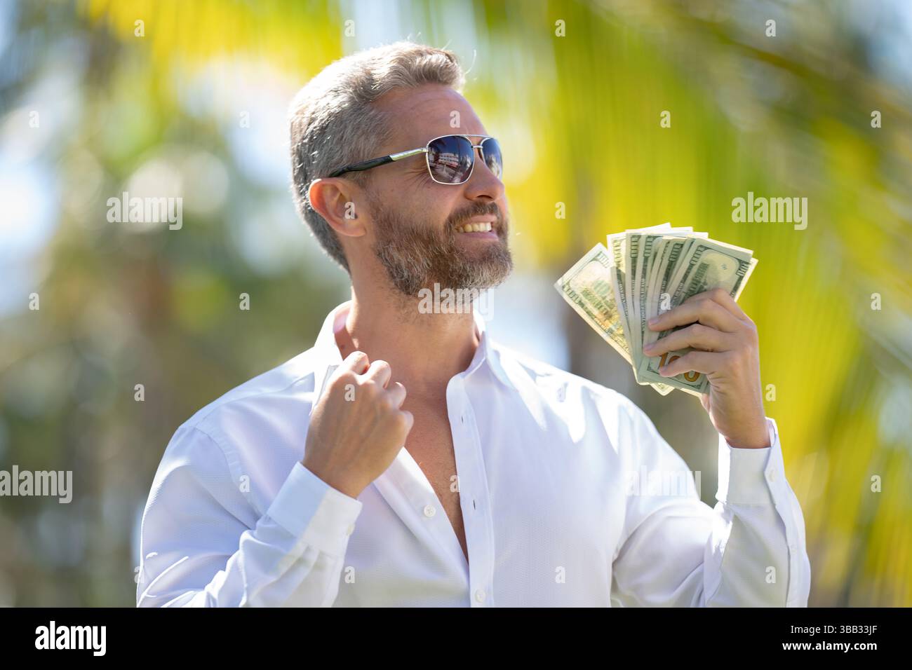 Rich businessman holding cash. Successful rich man counting dollar ...