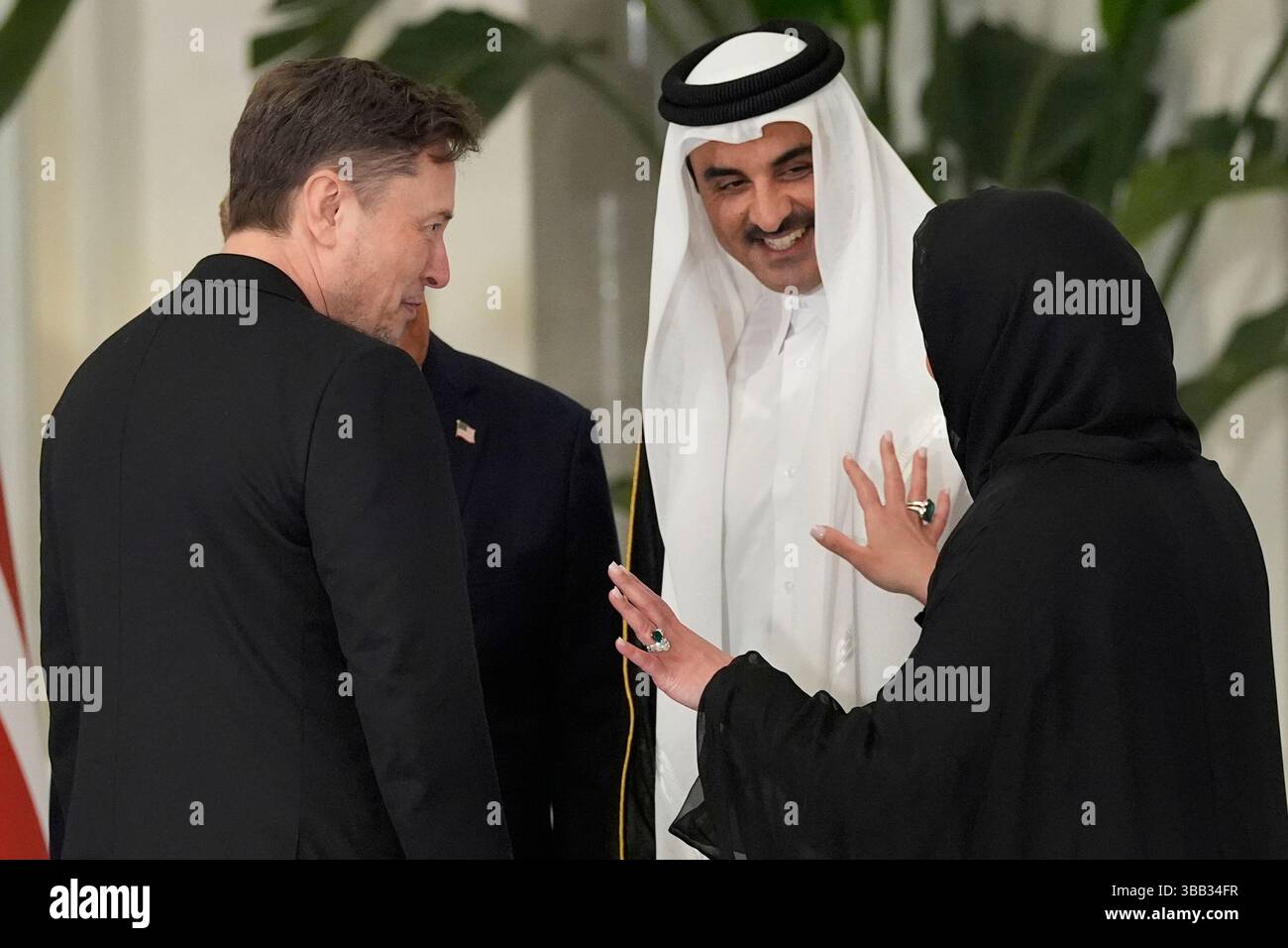 Elon Musk speaks with Qatar's Emir Sheikh Tamim bin Hamad Al Thani as ...