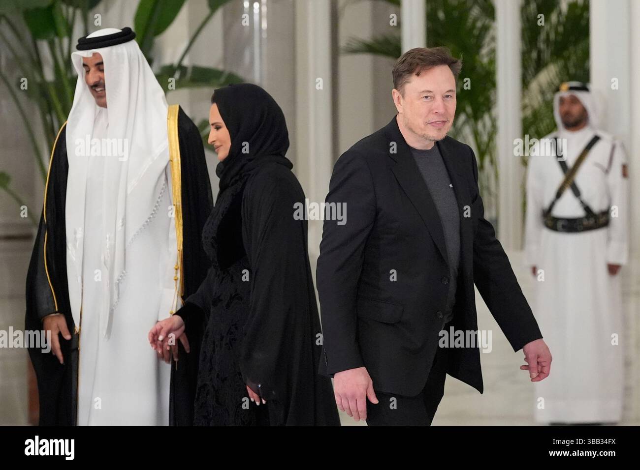Elon Musk gestures as he arrives for a state dinner hosted by Qatar's Emir Sheikh Tamim bin ...