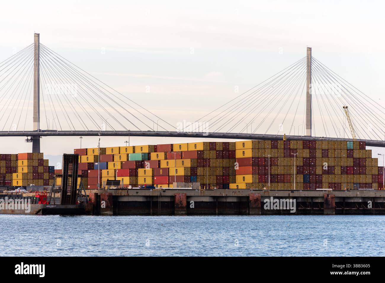 A large stack of shipping containers sit at the Port of Long Beach ...