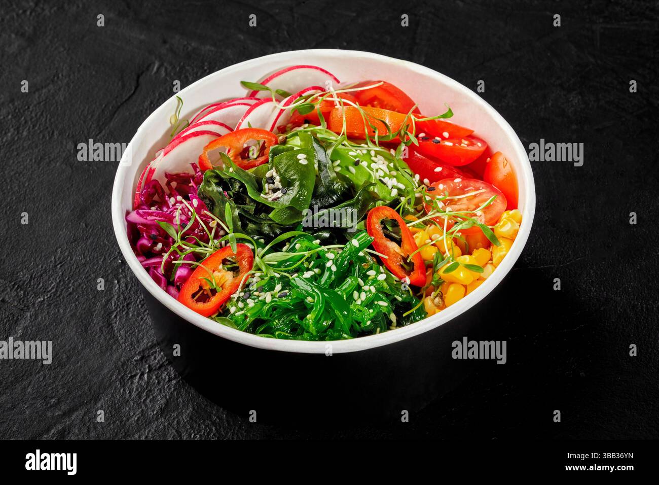 Colorful vegan poke bowl with corn, chuka seaweed, tomatoes and ...