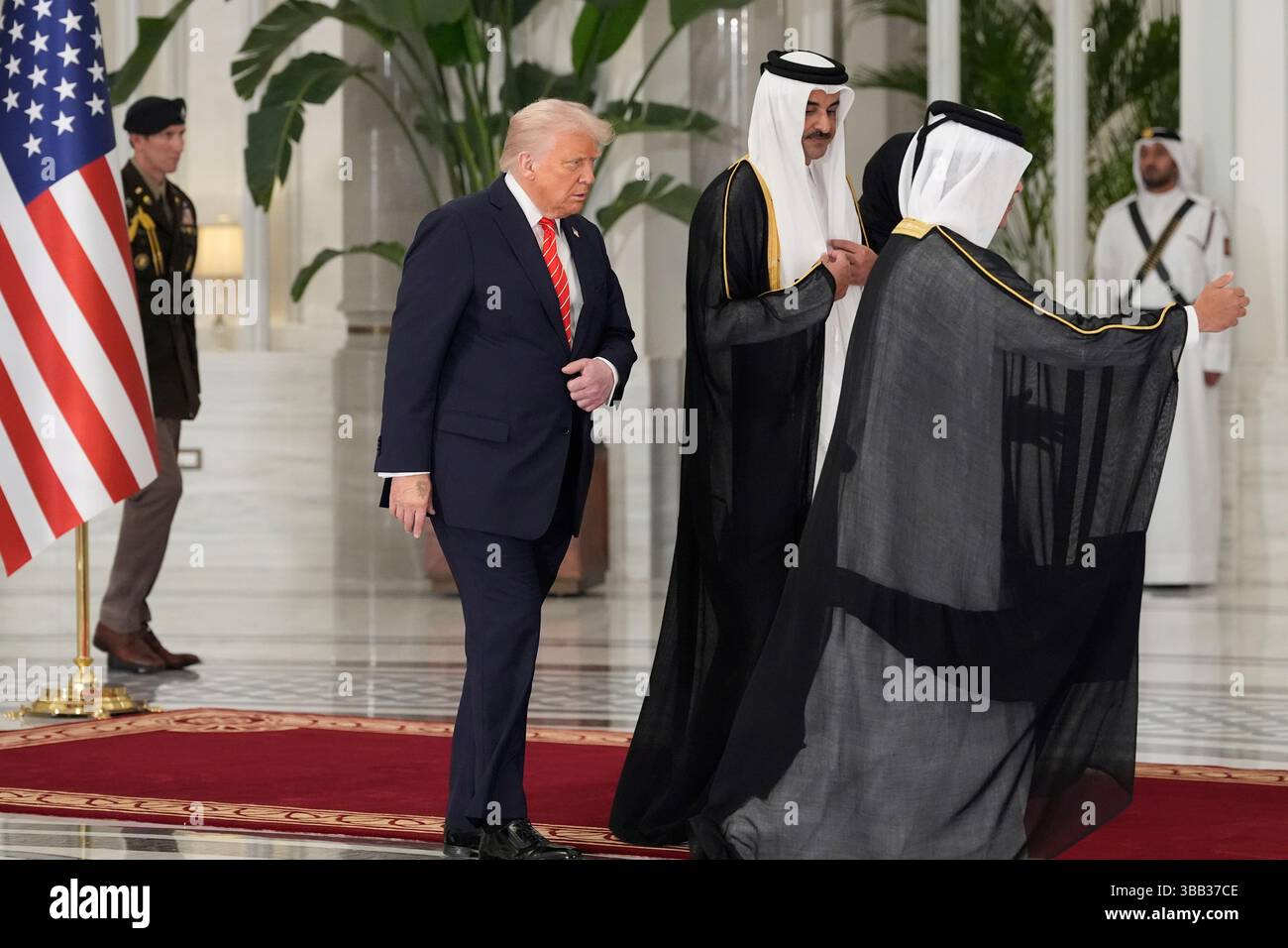 President Donald Trump and Qatar's Emir Sheikh Tamim bin Hamad Al Thani walk during a state ...