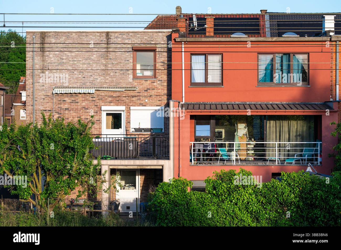 Back facade of houses in a row along the railway tracks in Ruisbroek ...