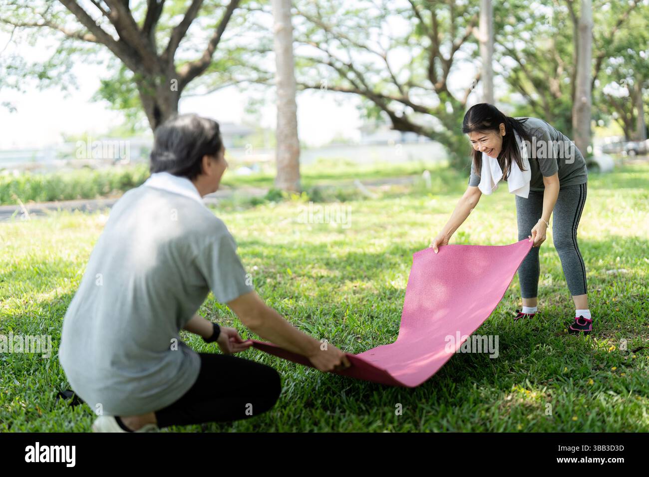 Wellness and teamwork: Seniors couple laying down yoga mat Stock Photo ...