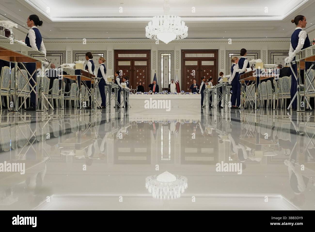 President Donald Trump salutes during the U.S. national anthem as Qatar ...