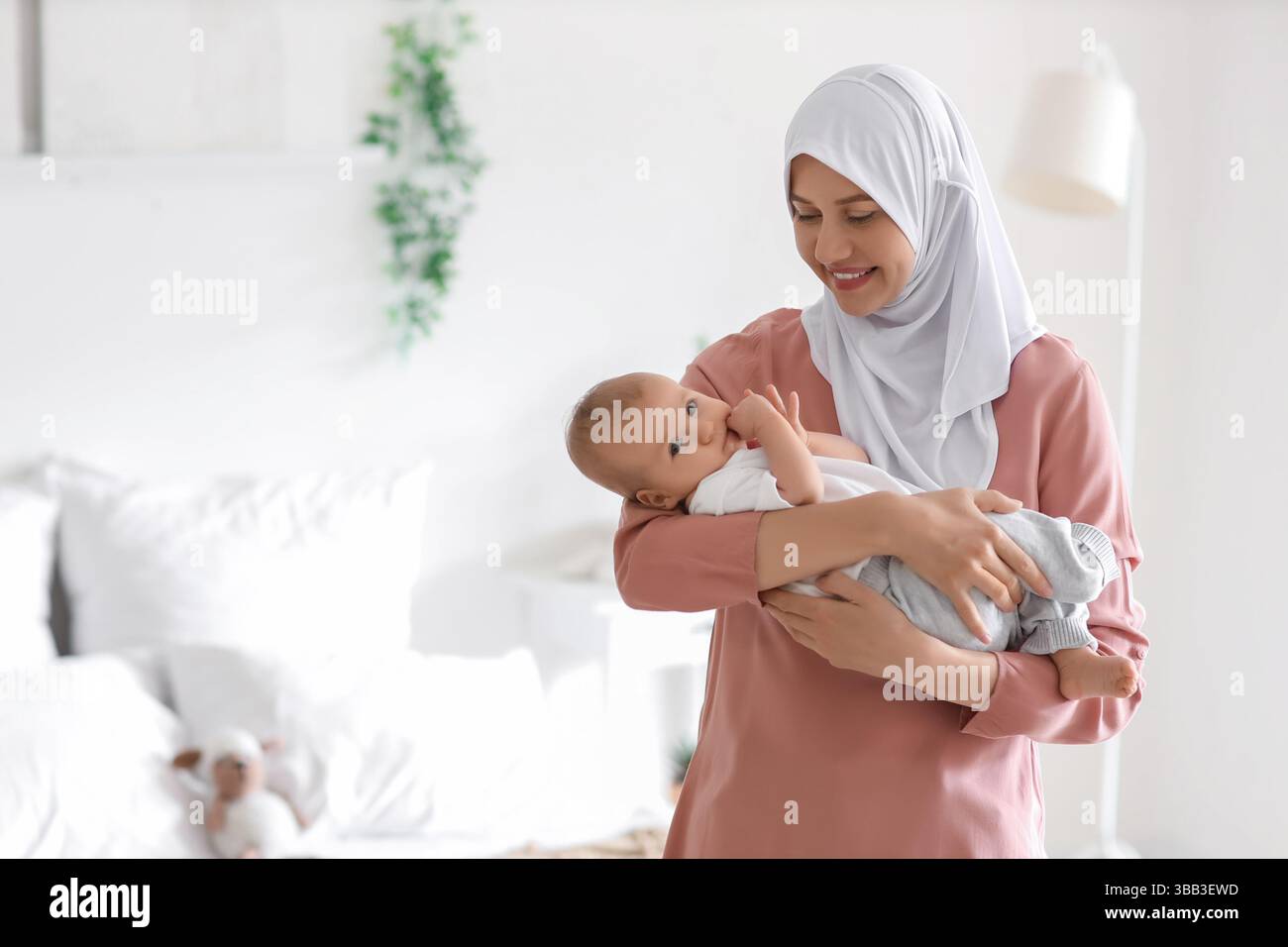 Happy Muslim mother in hijab with cute little baby at home Stock Photo ...