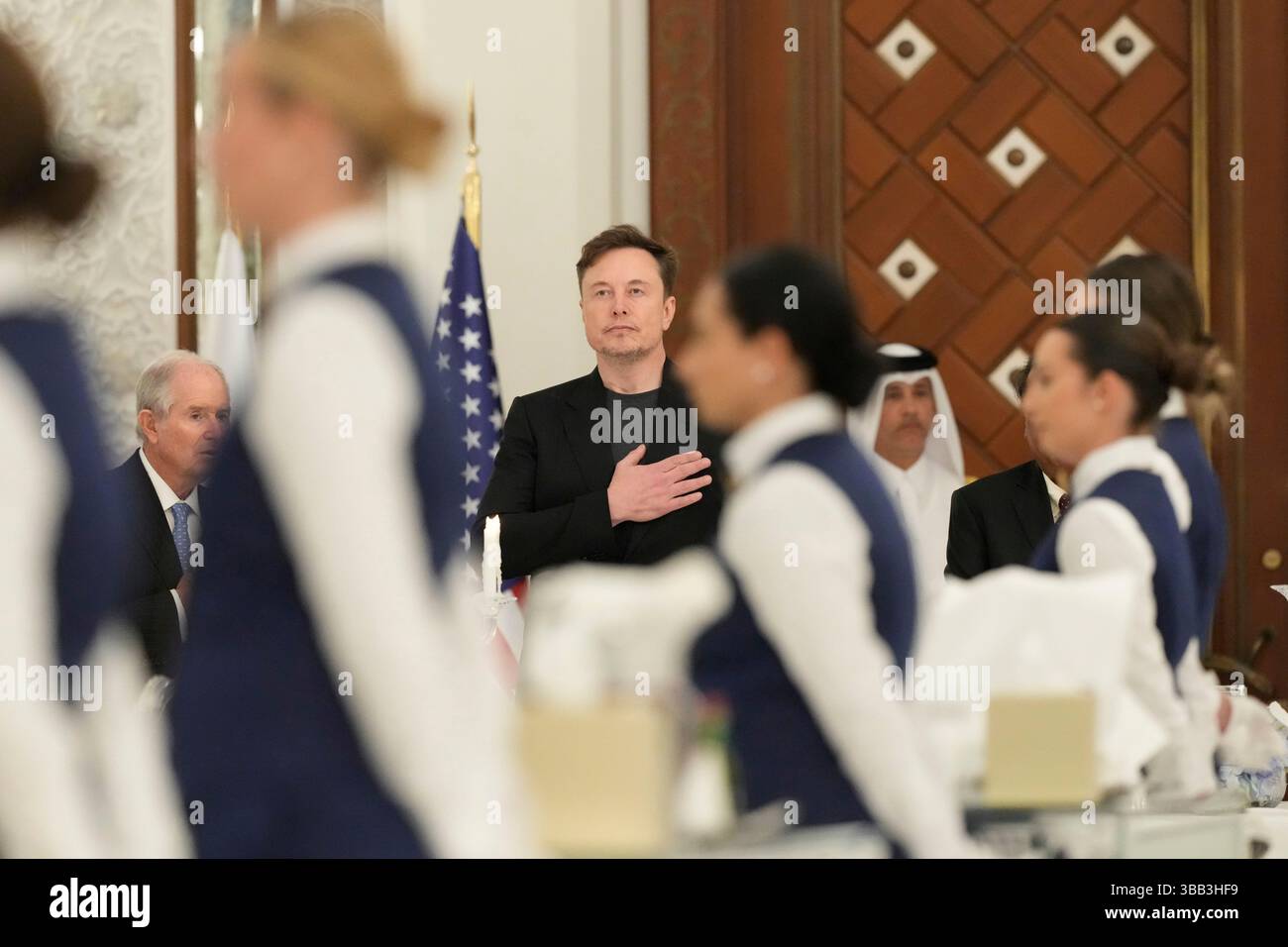 Elon Musk salutes during the U.S. national anthem for a state dinner ...