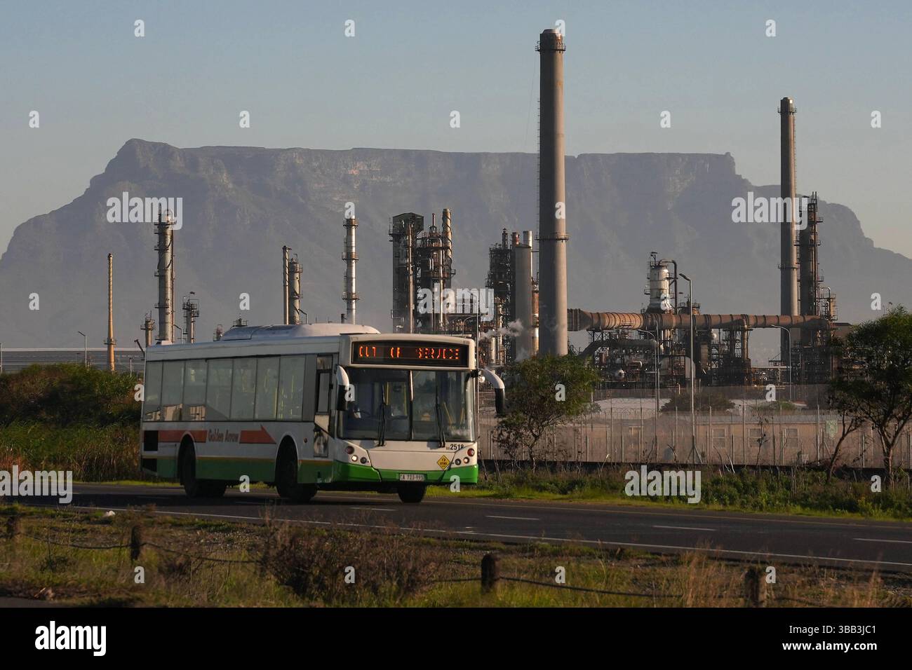 Astron Energy oil refinery in Cape Town, South Africa A bus drives past ...