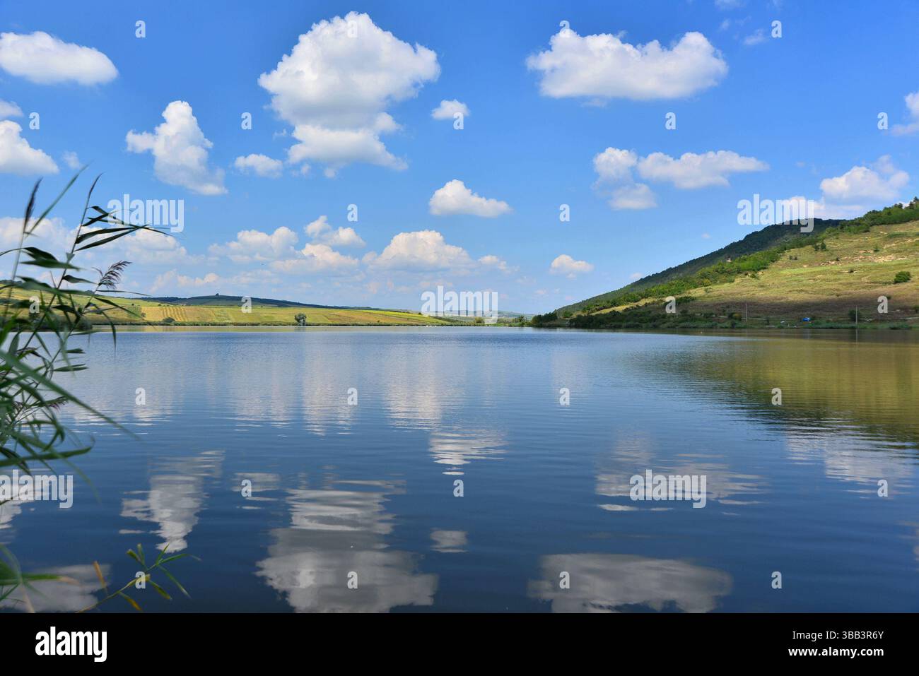 Water cycle, lake Victor in Transylvania with reflected cumulus clouds ...
