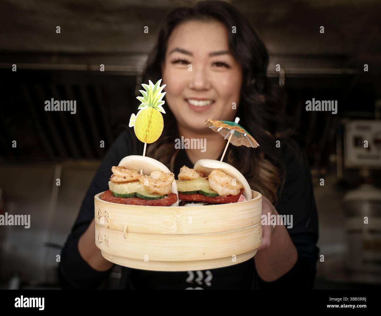 Calgary, Canada. 14th May, 2025. Tracy Cheng, of Dumpling Hero, shows ...