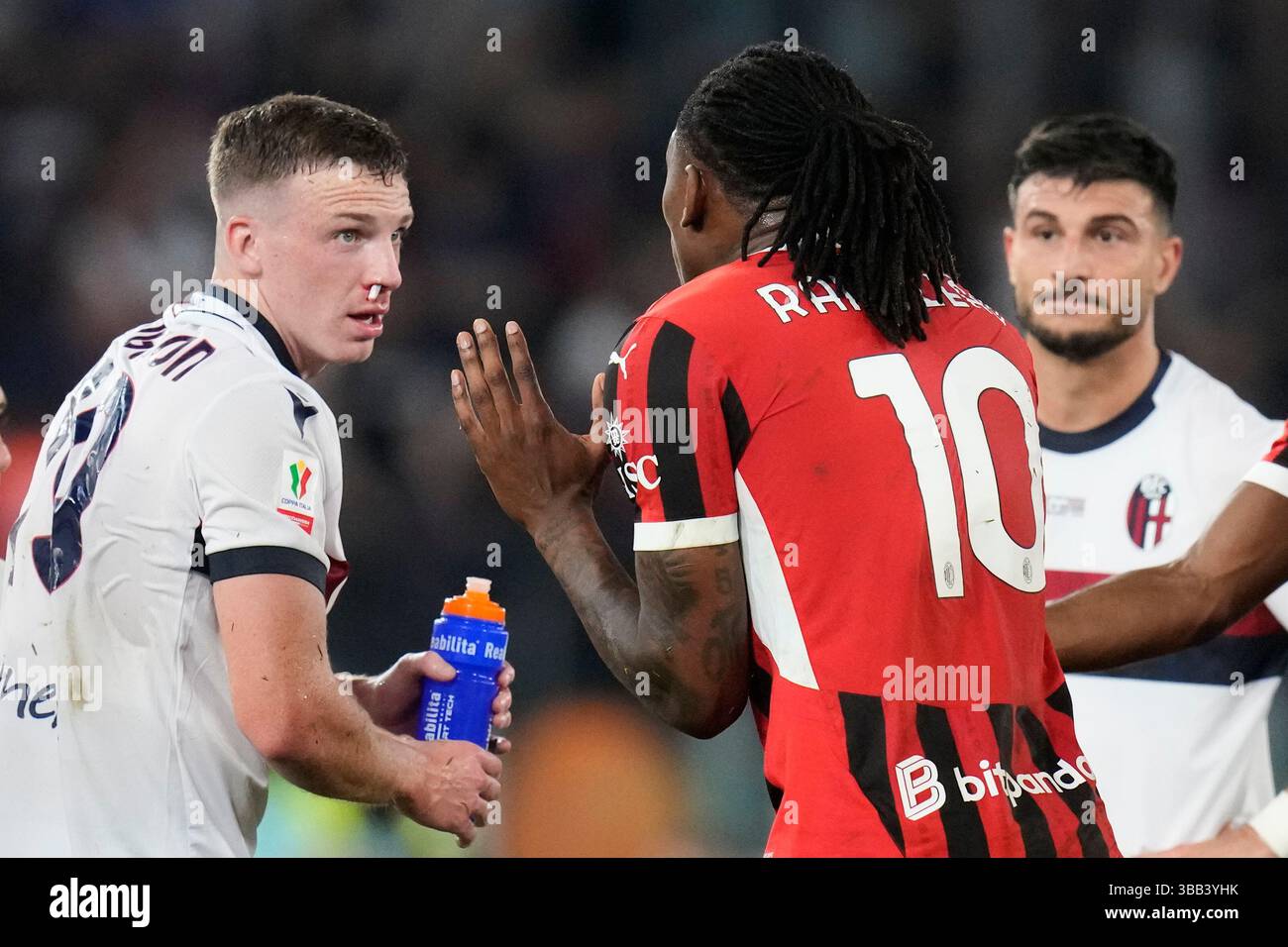 AC Milan's Rafael Leao, centre, and Bologna's Lewis Ferguson, left ...