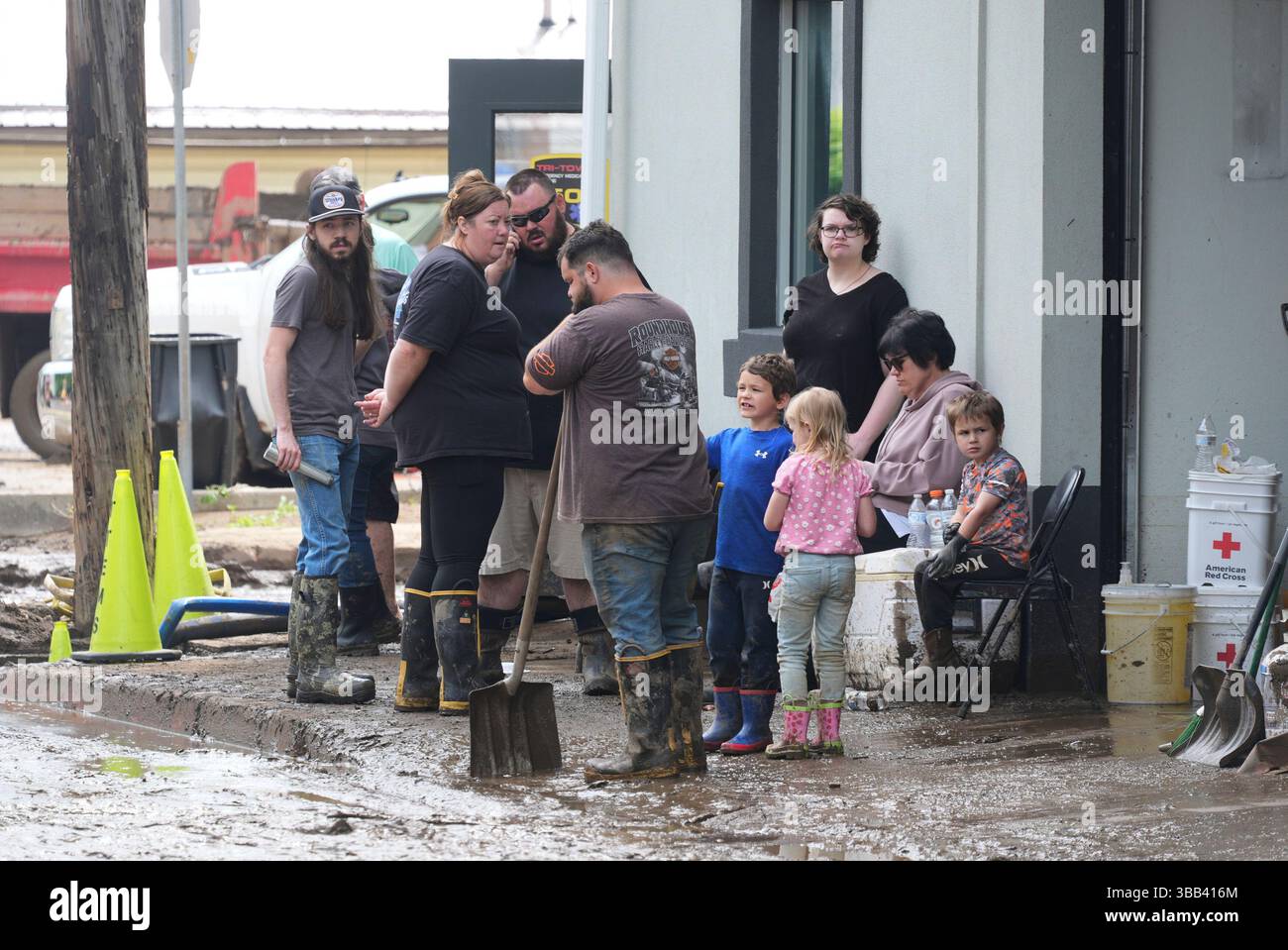People gather as clean up continuesafter flooding on Wednesday, May 14 ...
