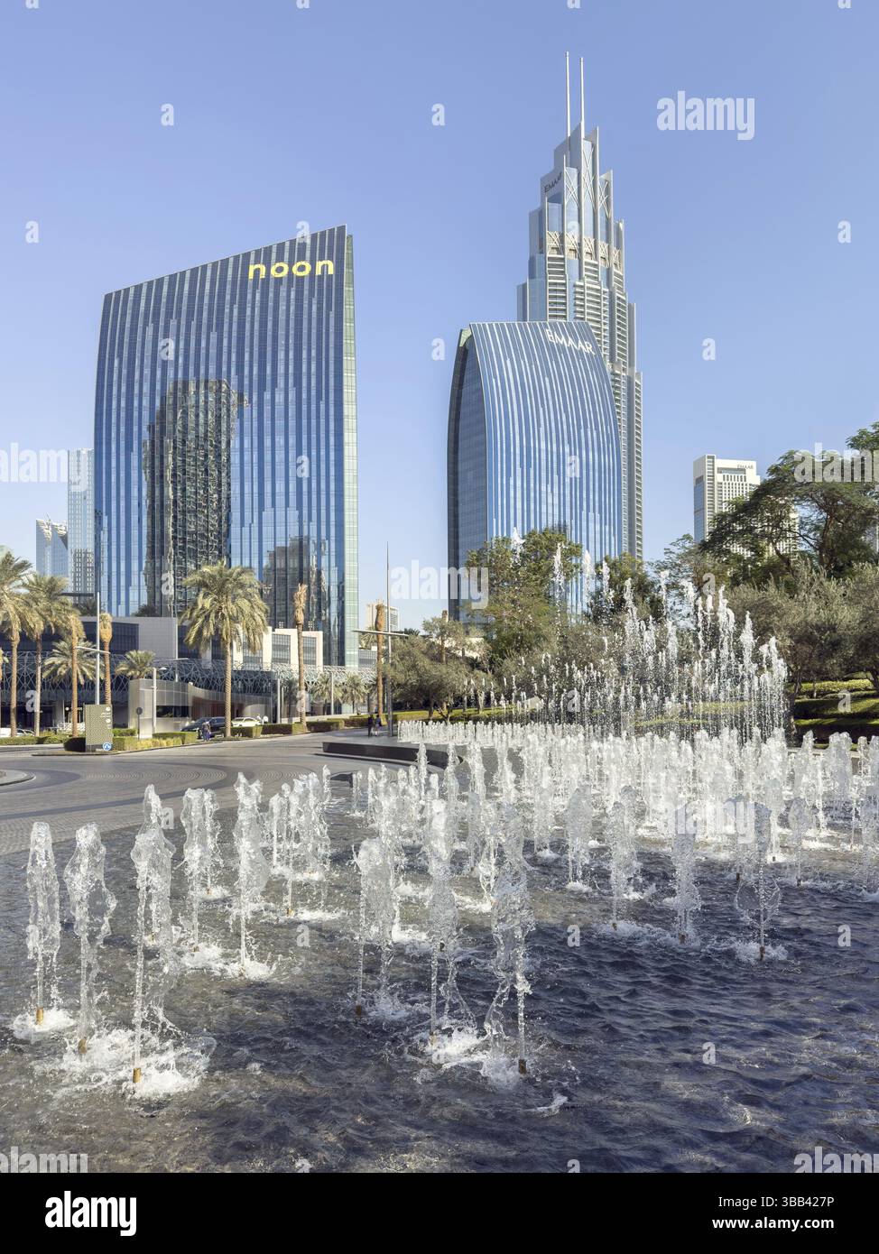 Modern skyscrapers with glass facades, fountains in the foreground and ...