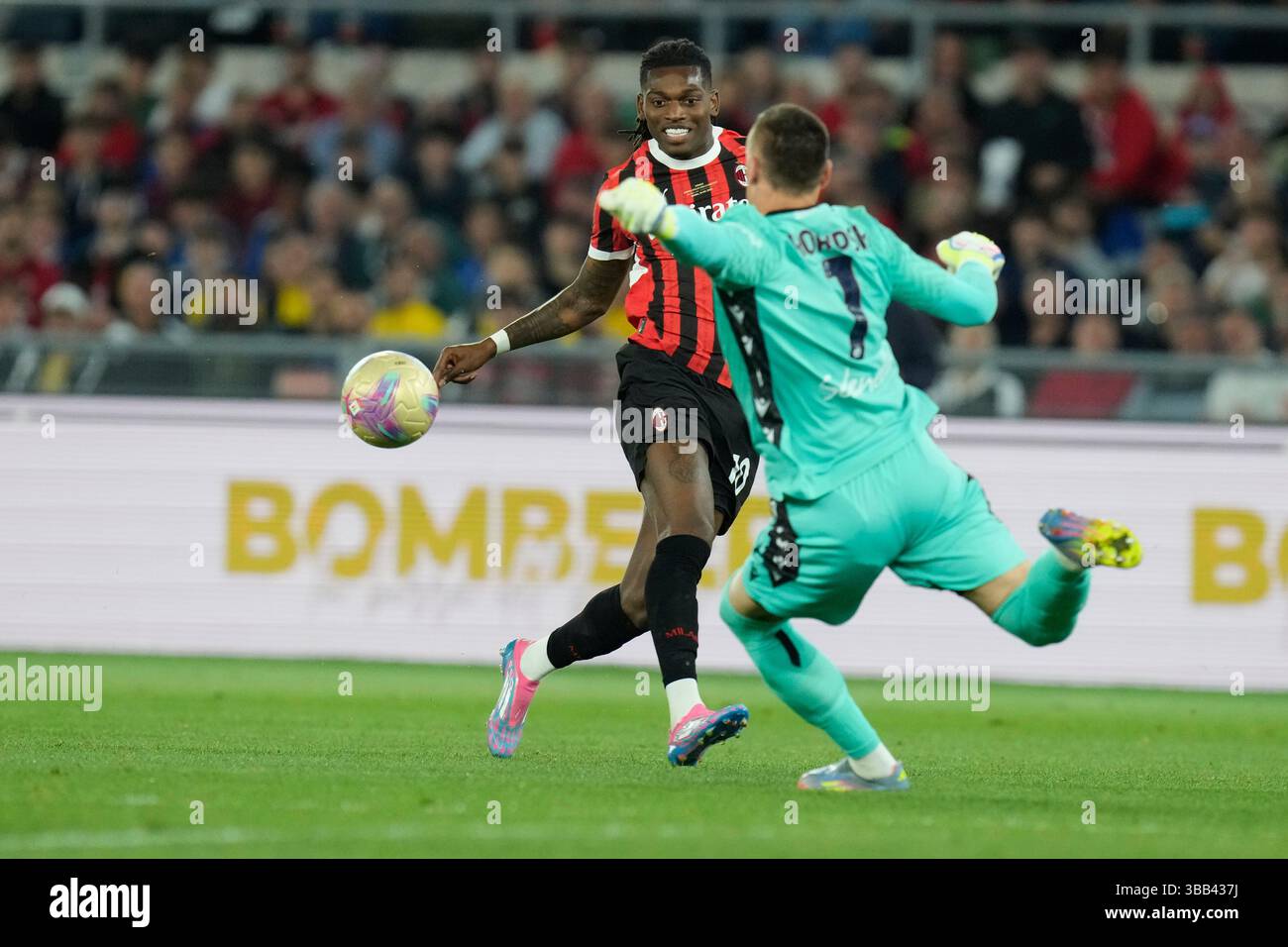 AC Milan's Rafael Leao, left, and Bologna's goalkeeper Lukasz Skorupski ...