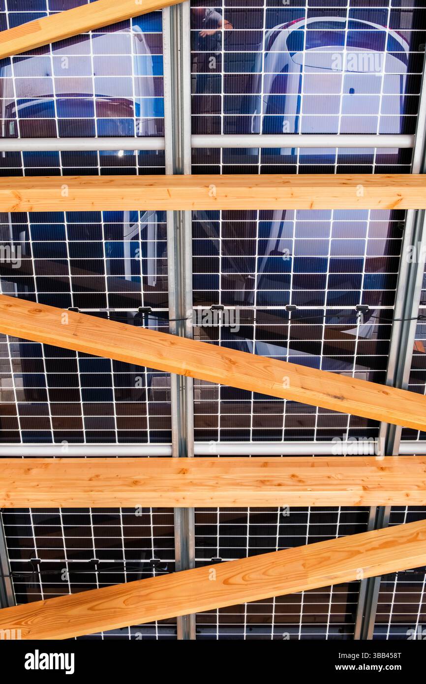 The solar panels are strategically placed above a car parking area ...