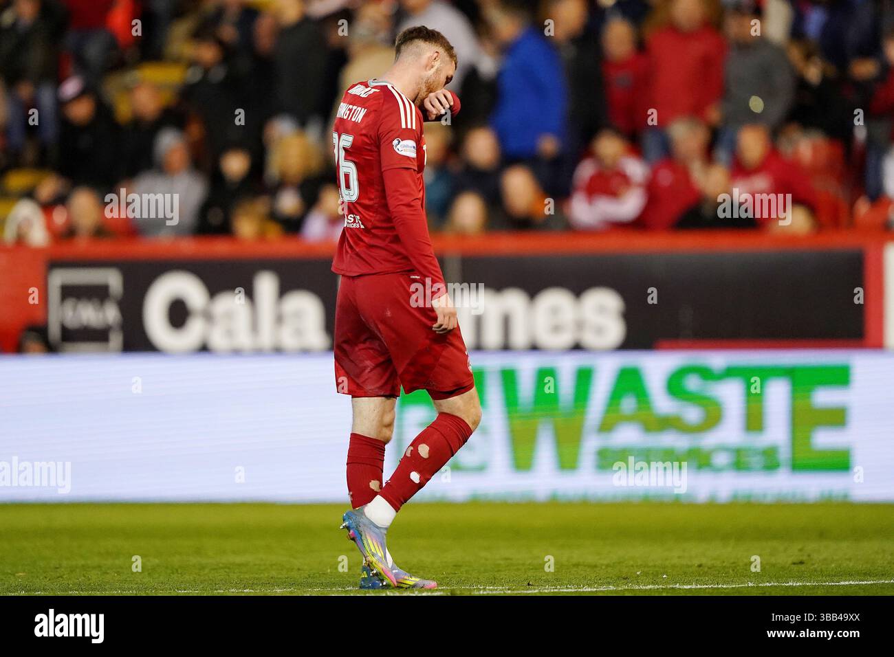 Aberdeen's Jayden Richardson leaves the pitch dejected after being ...
