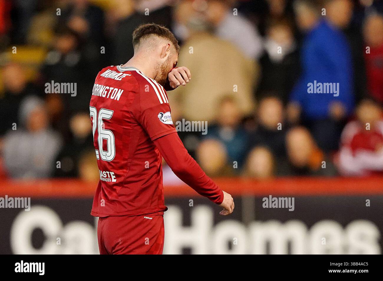 Aberdeen's Jayden Richardson leaves the pitch dejected after being ...