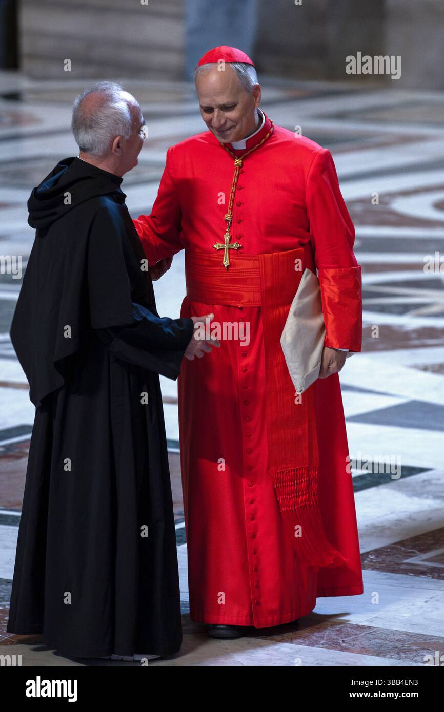 Cardinal Robert Francis Prevost speaks with a priest upon his arrival ...