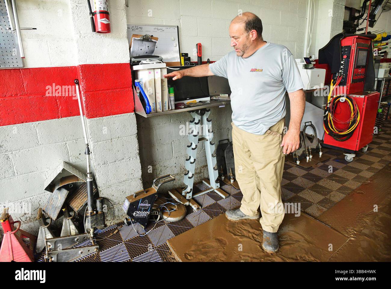Mark Smith, owner of MS Shock Therapy, points to the high water mark ...
