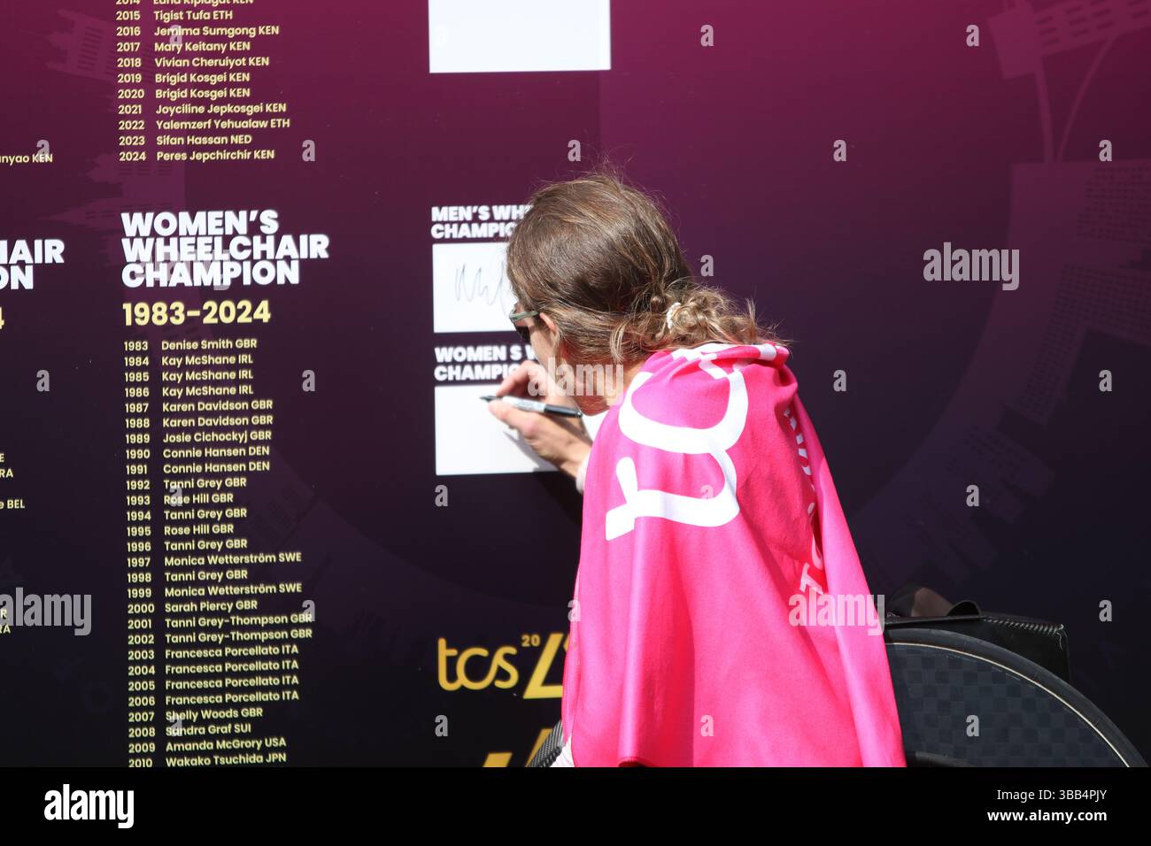 Catherine Debrunner of Switzerland celebrates by signing the winners ...