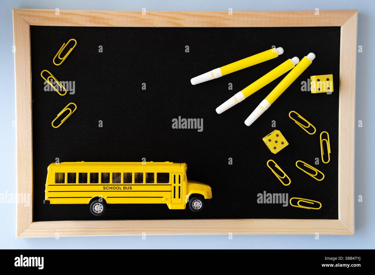 Minimalist school concept with blackboard yellow school bus markers ...