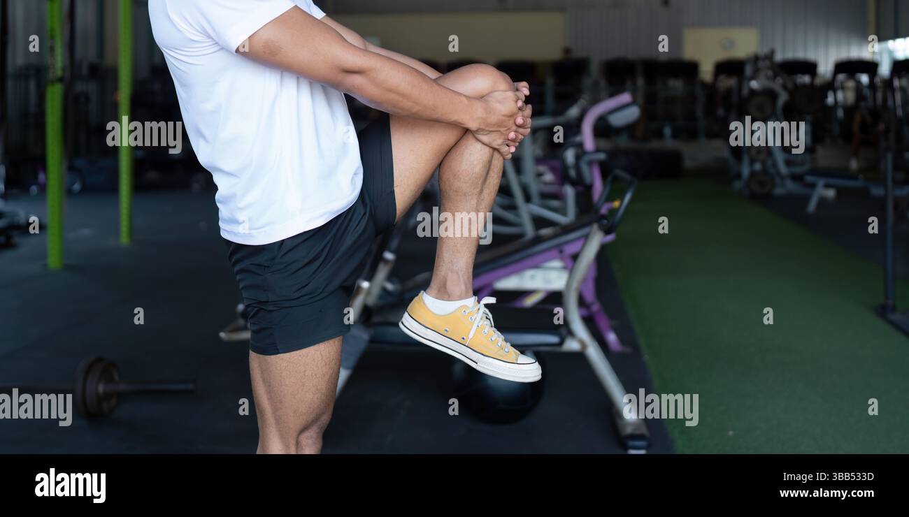 Wellness and Strength. Young man performing a knee lift exercise in a ...