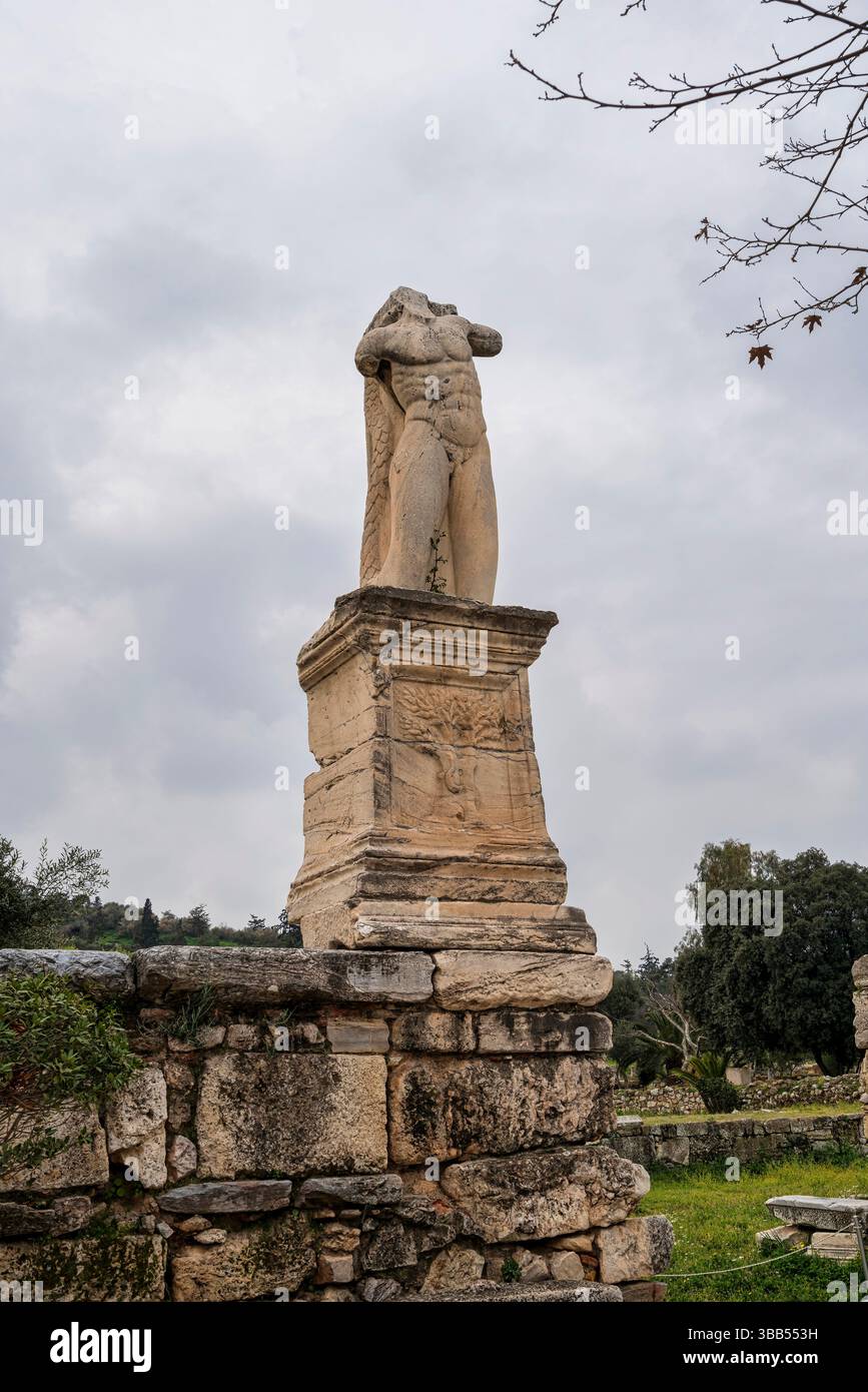 Close-up of a broken marble statue without a head, standing on a ...