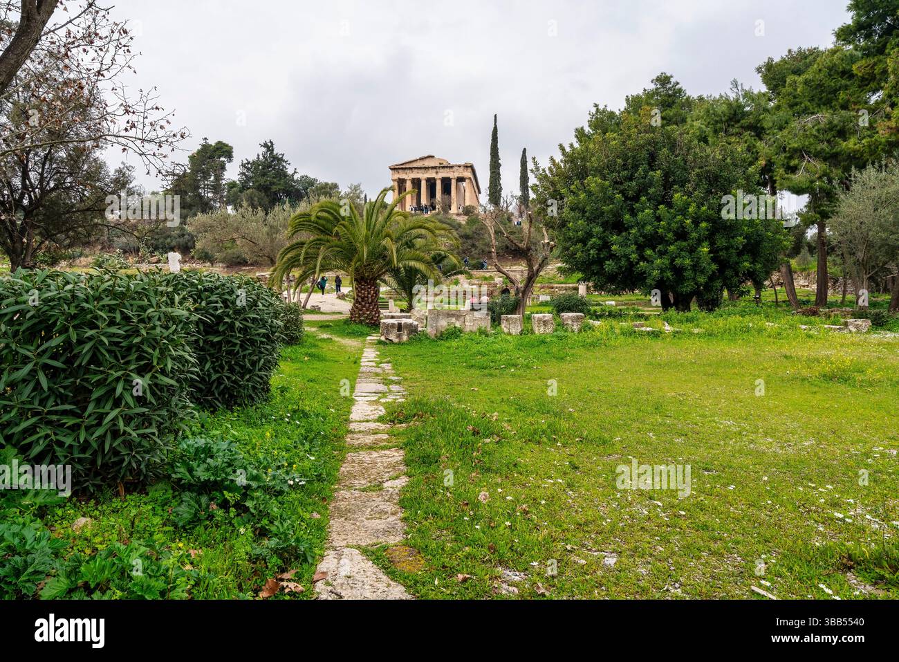 Pathway through lush greenery and ruins in the Ancient Agora leading to ...