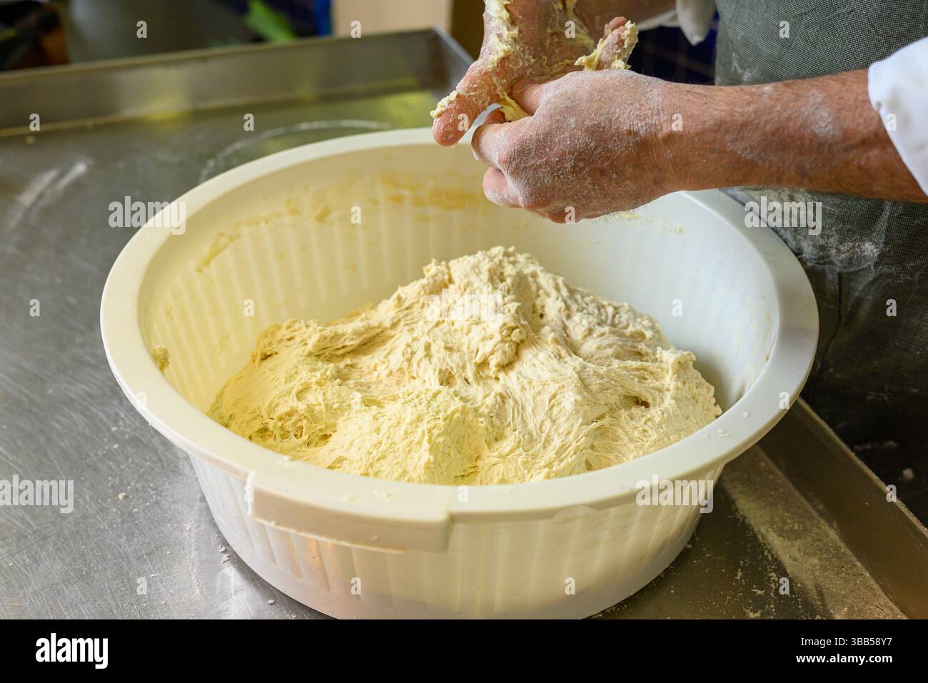 close up of working hands mixing dough Stock Photo - Alamy