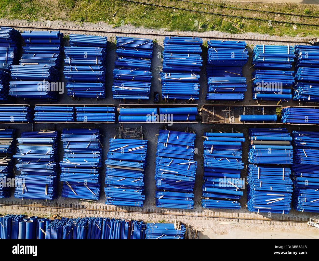 Stack of cast iron pipes in loading area waiting for transportation ...