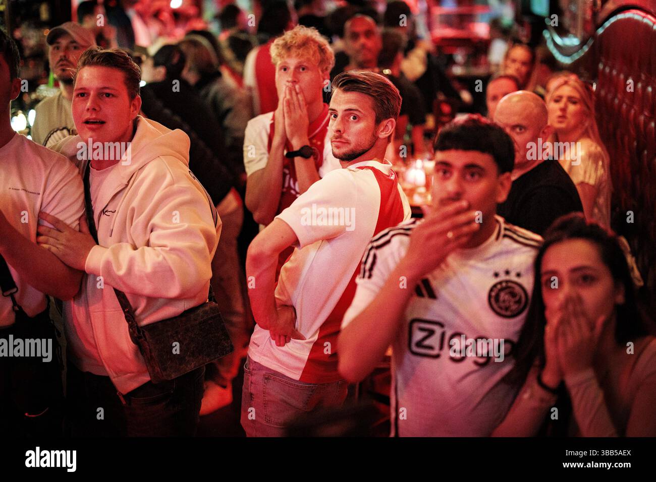 Fans of Ajax are following the premier league match between Groningen ...