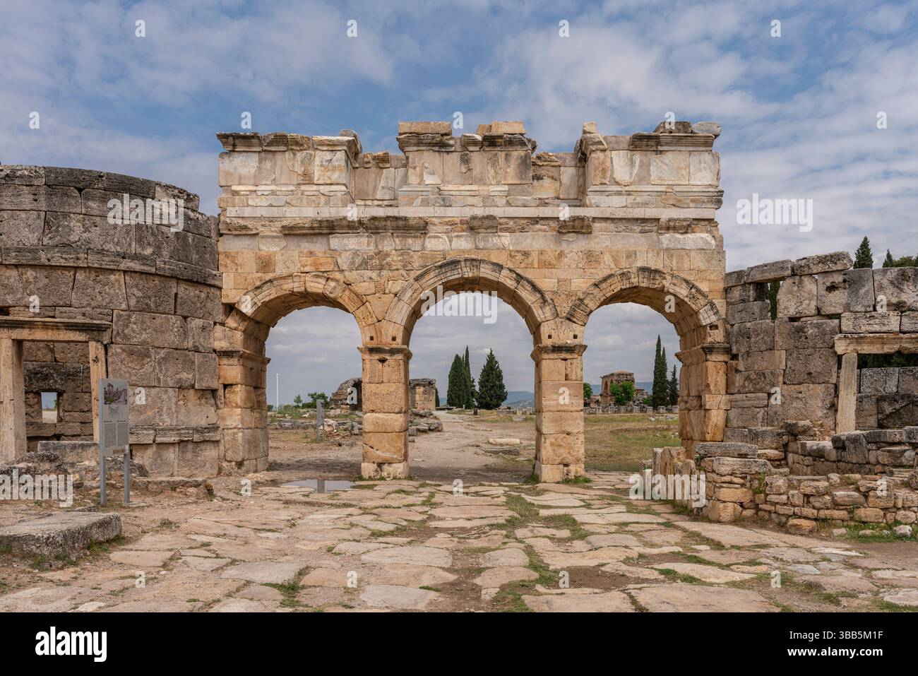 A monumental triple-arched gateway with flanking towers forms the Arch ...