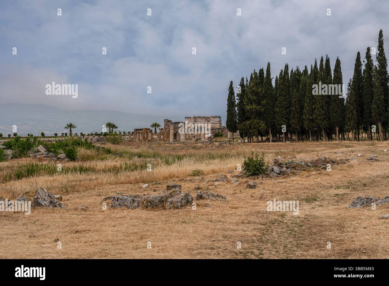 Stone ruins and grassy fields mark the site of the Agora at Hierapolis ...
