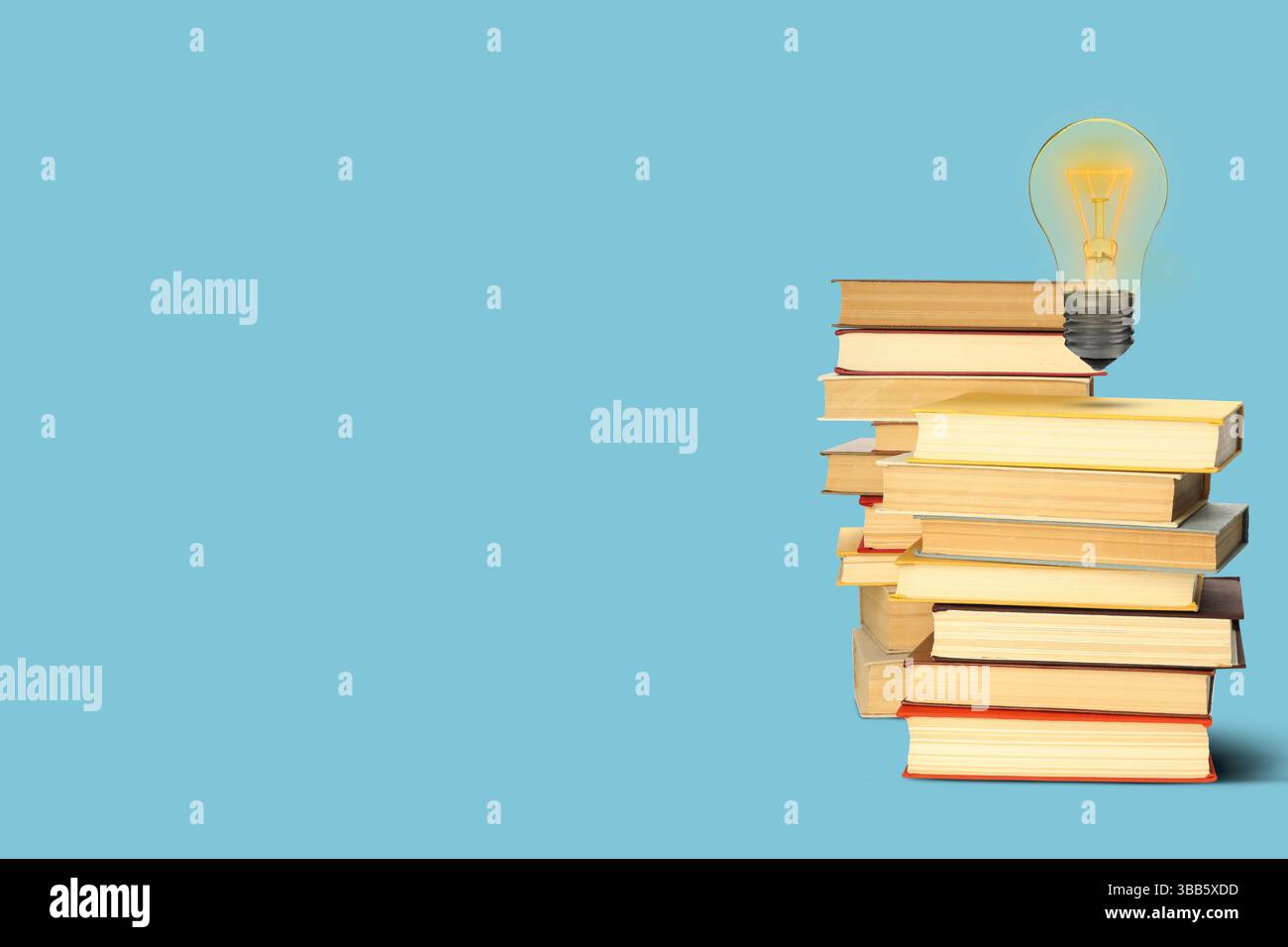 Idea and knowledge. Light bulb in air over stack of books on light blue background, space for ...