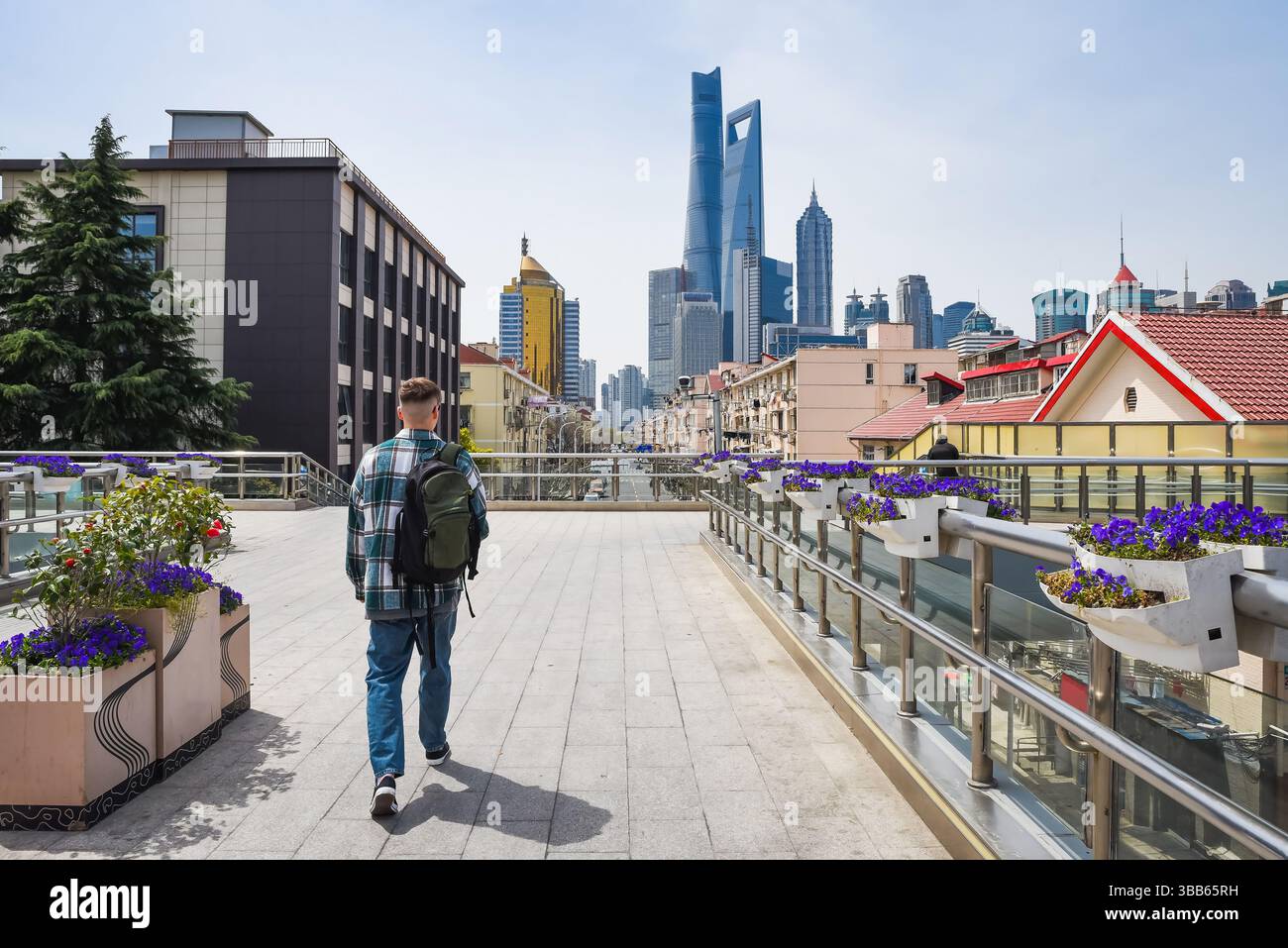 Wide view of a tourist crossing a bridge in Pudong, Shanghai, with ...