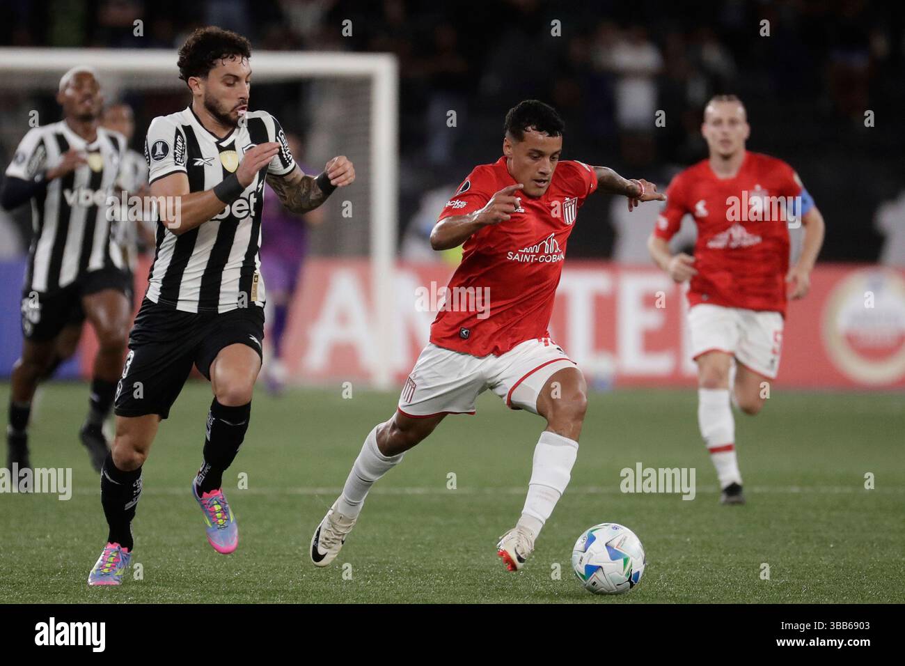 Tiago Palacios of Argentina's Estudiantes de La Plata, center, controls ...