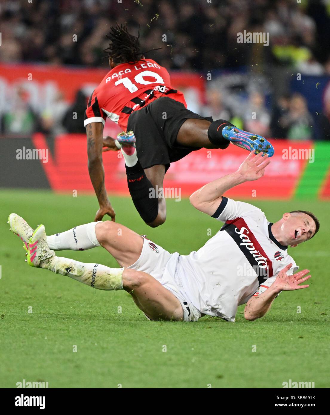 Rome, Italy. 14th May, 2025. AC Milan's Rafael Leao (top) vies with ...