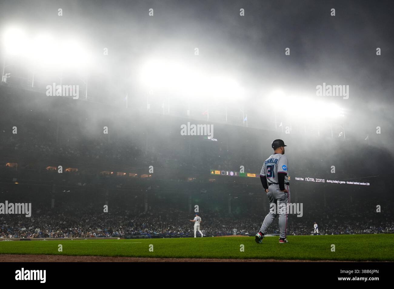 Fog rolls through Wrigley Field during the eighth inning of a baseball ...