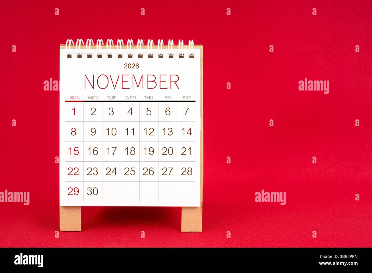 Blank desk calendar for November 2026 on red color background Stock ...