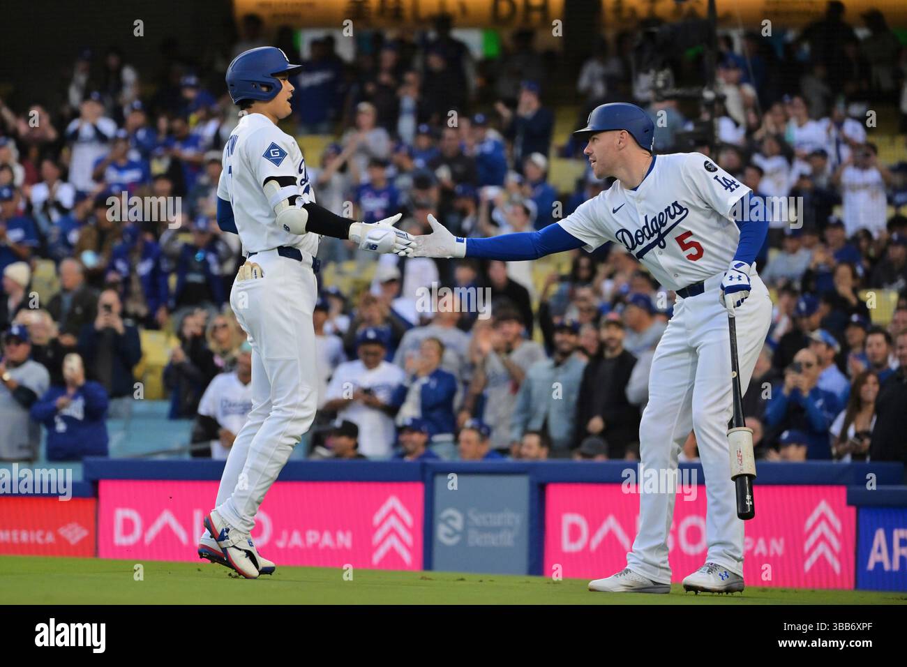 Los Angeles Dodgers' Shohei Ohtani, left, celebrates his solo home run ...