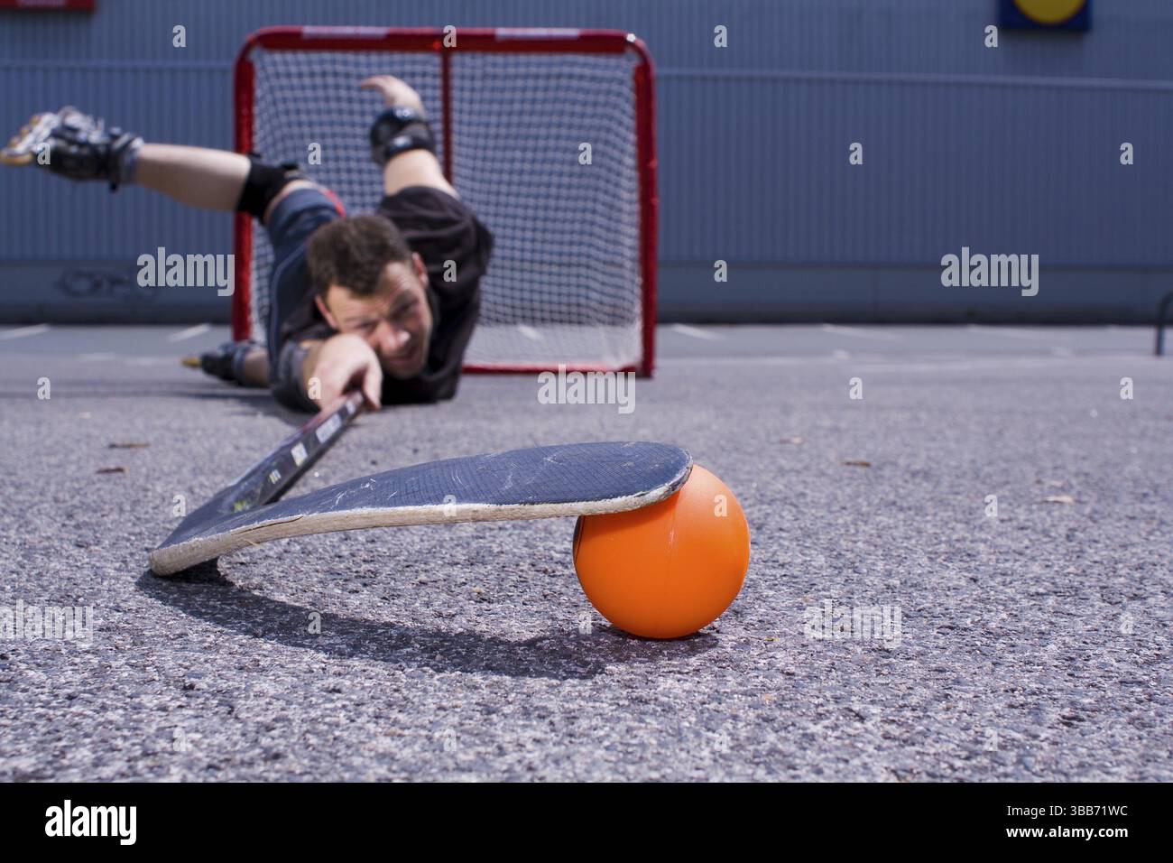 Street hockey player in action Stock Photo - Alamy