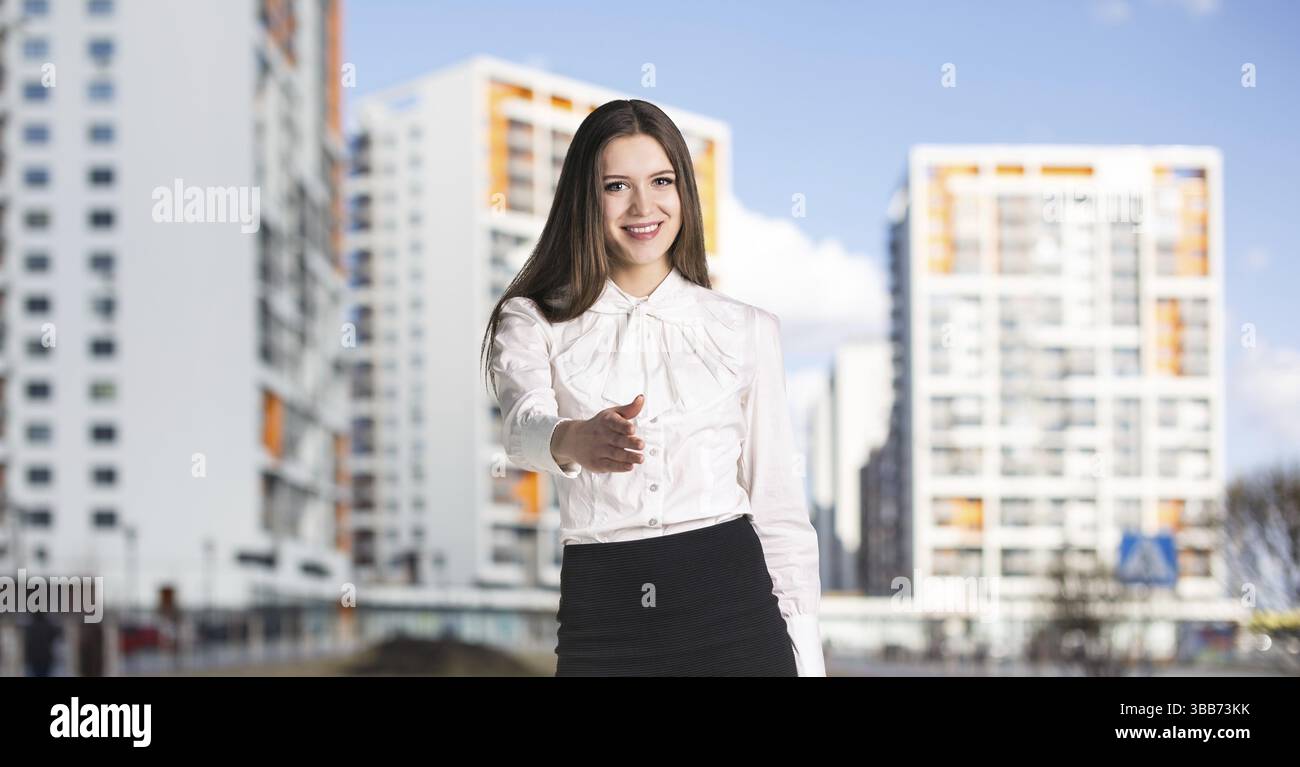 Woman stands smiling in city hi-res stock photography and images - Alamy