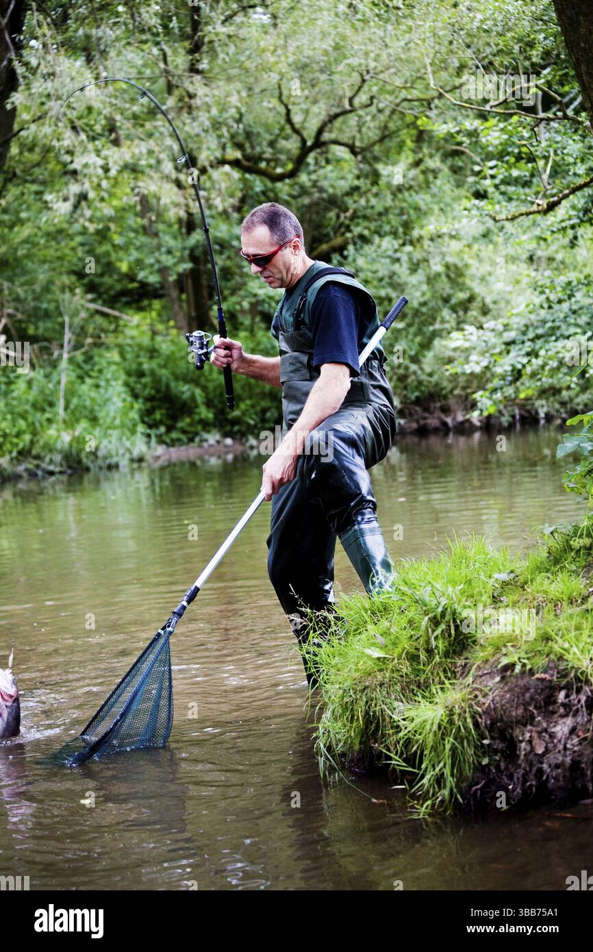 A angler fishing in the river Stock Photo - Alamy