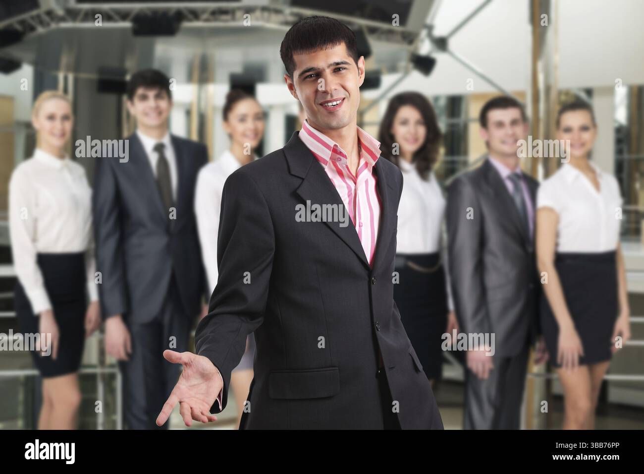 Group of business people stand in a modern office hall Stock Photo - Alamy