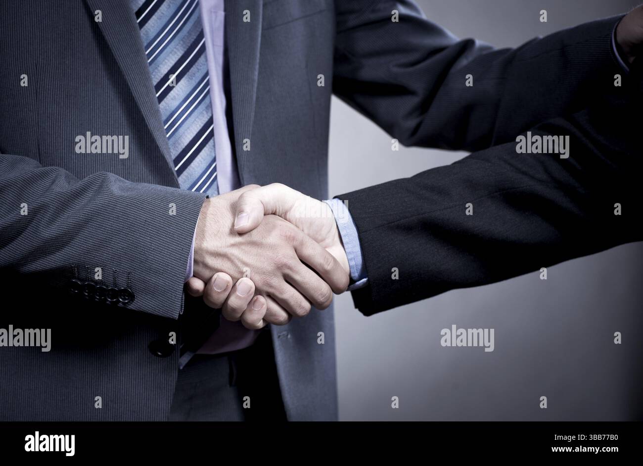 Two suited men shaking hands Stock Photo - Alamy