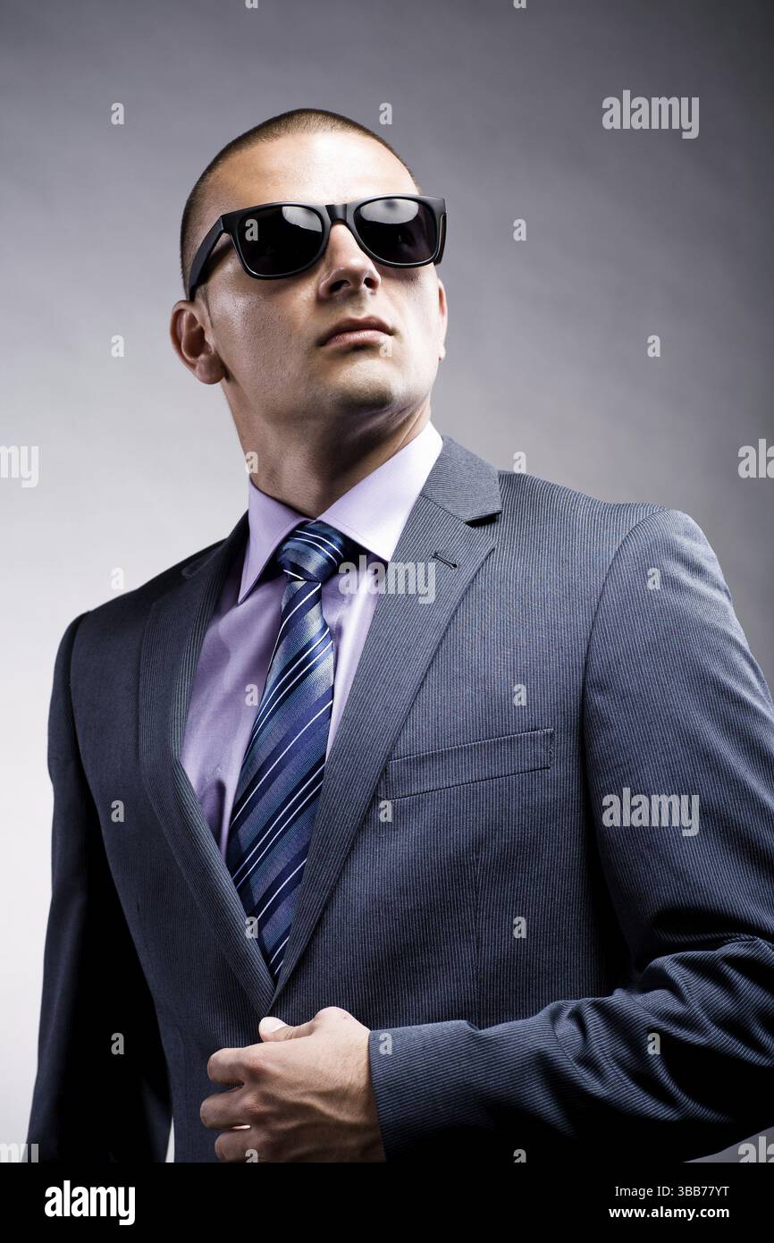 Portrait of a young suited man Stock Photo - Alamy