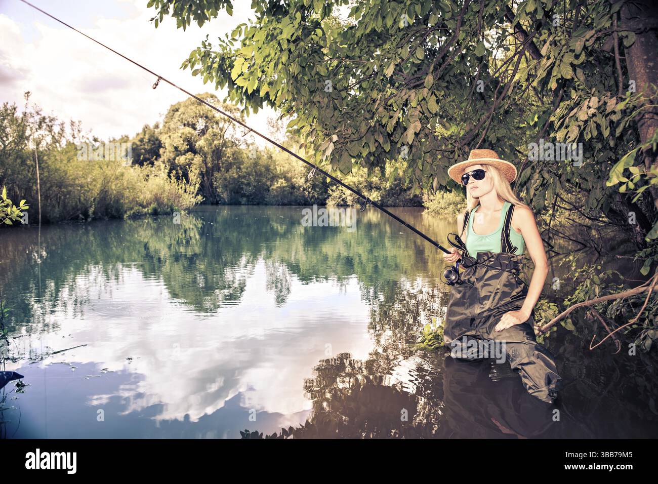 The outdoor portrait of a young fishing woman Stock Photo - Alamy