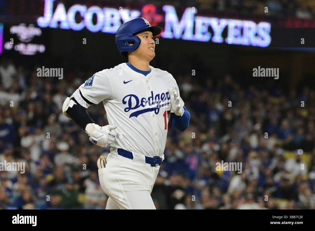 Los Angeles Dodgers' Shohei Ohtani runs out a infield ground out in the ...